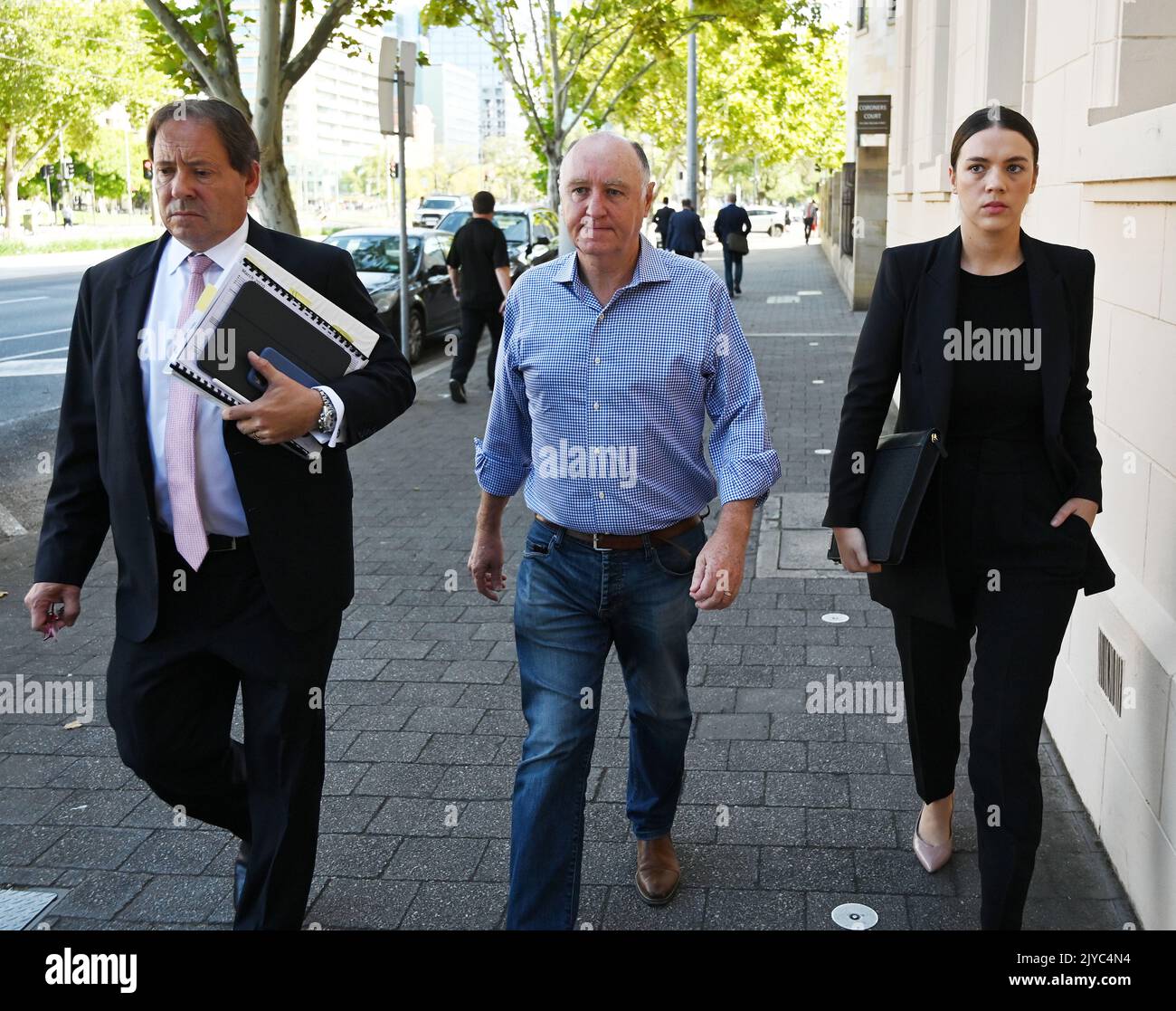 Former Renewal SA chief executive John Hanlon (centre) departs the ...