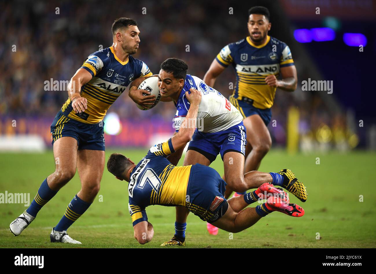 Reimis Smith of the Bulldogs is tackled by Mitchell Moses of the Eels ...