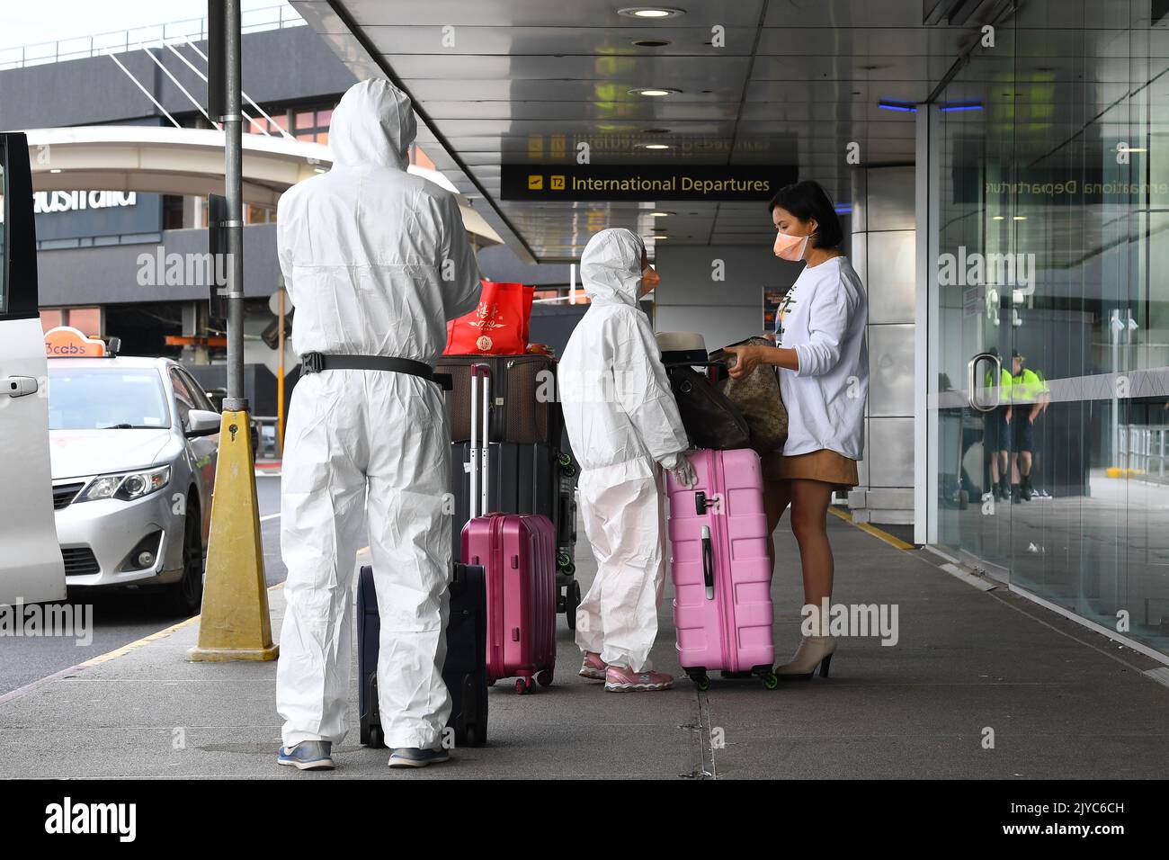 People are seen dressing in personal protective equipment outside the ...