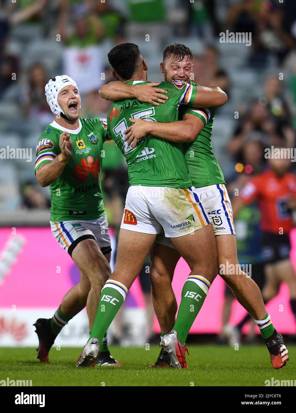 Jarrod Croker (left) and Nick Cotric react with try-scorer Elliott ...