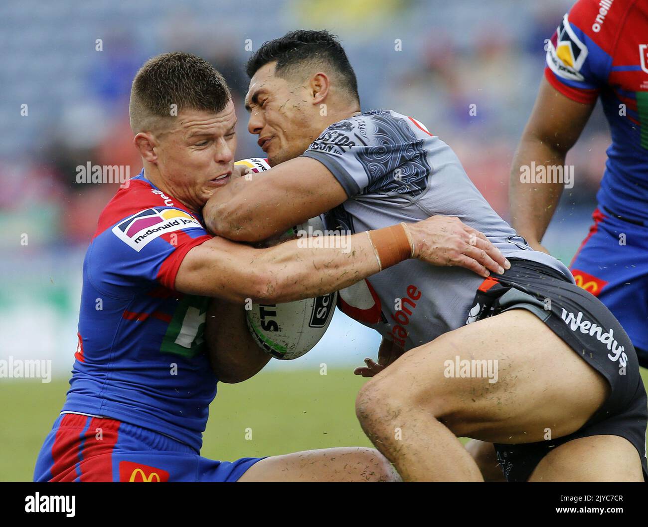 Roger Tuivasa-Sheck of the Warriors is tackled by Jayden Brailey during ...