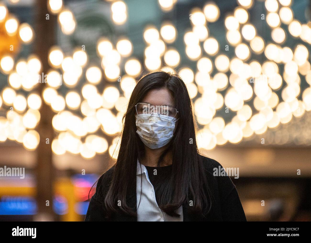 A woman seen wearing a protective face mask in Sydney, Monday, March 16 ...