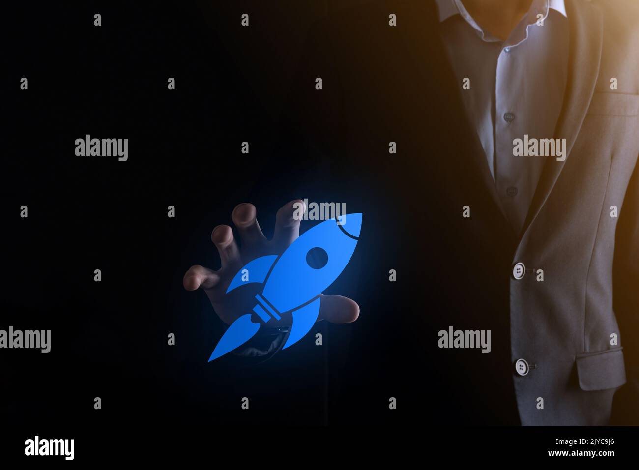 Start up concept with businessman holding abstract digital rocket icon ...