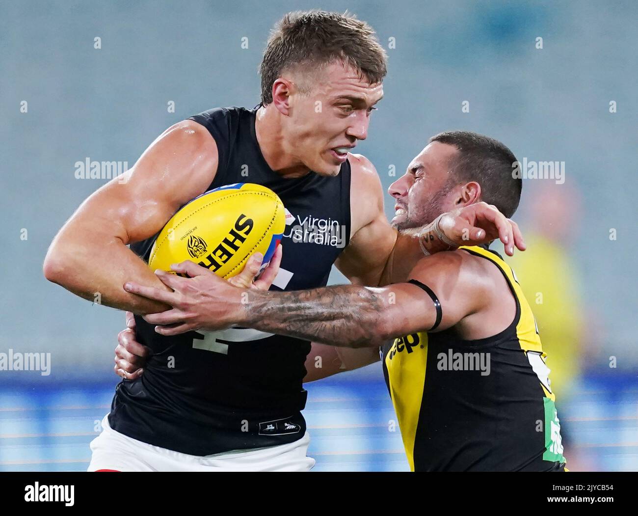Jack Graham of the Tigers tackles Patrick Cripps of the Blues during ...