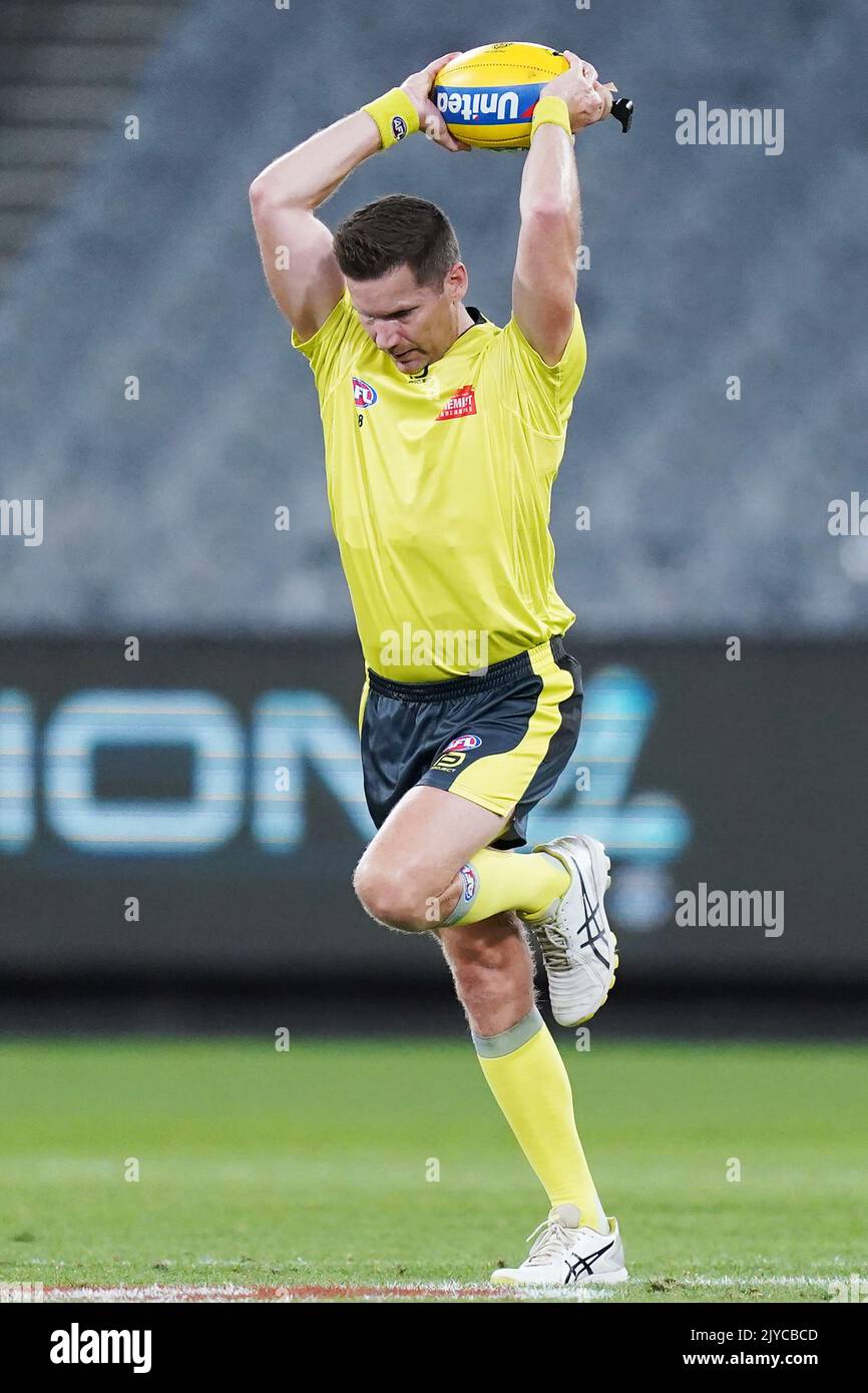 An umpire bounces the ball during the Round 1 AFL match between ...