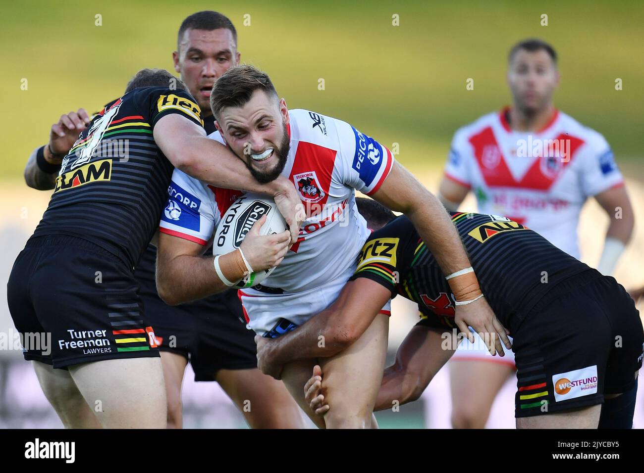 Jacob Host of the Dragons is tackled by Nathan Cleary and Liam Martin ...