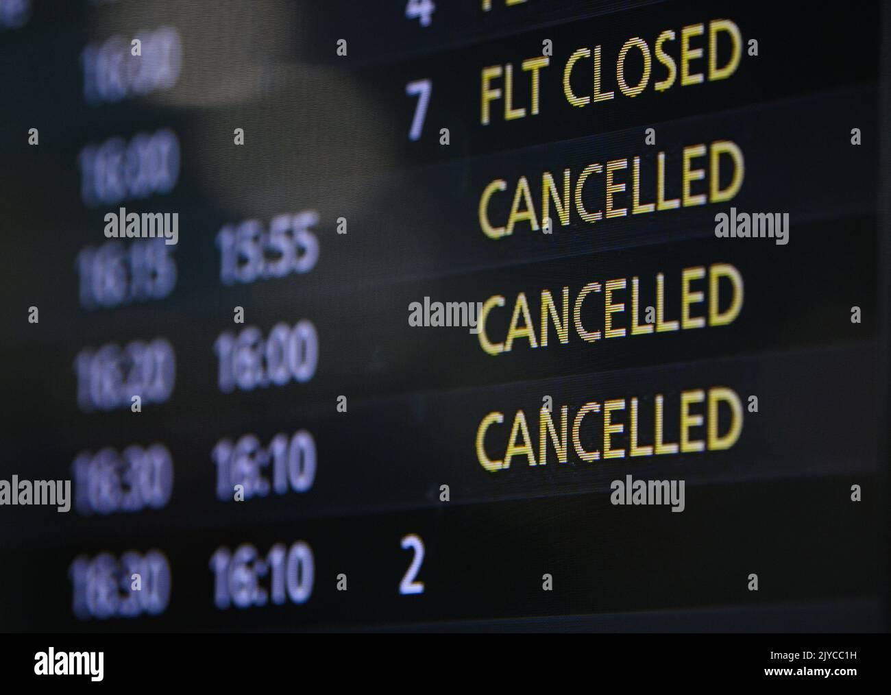 A flight information board showing several cancelled flights, Sydney ...