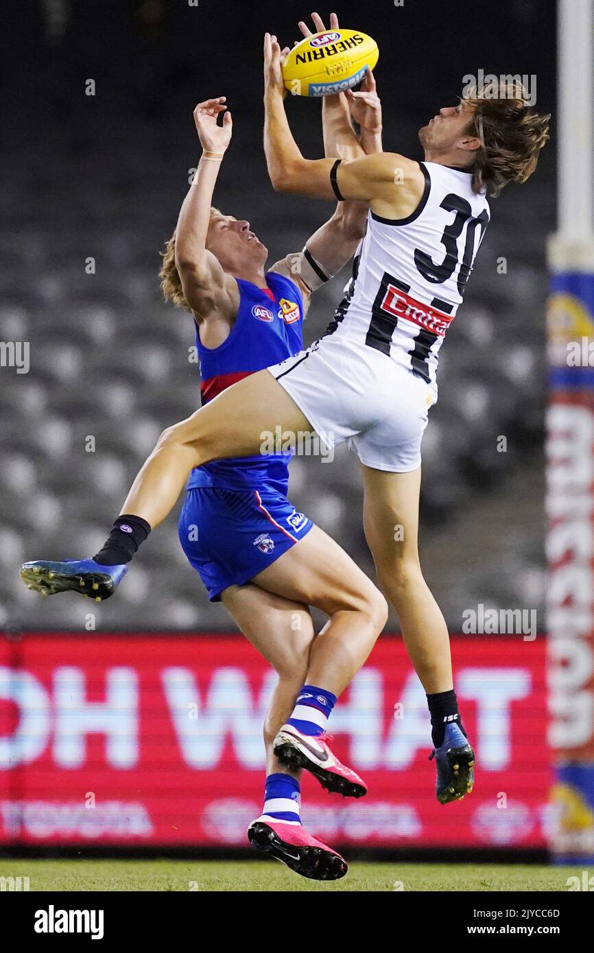 Darcy Moore of the Magpies marks the ball against Aaron Naughton of the ...