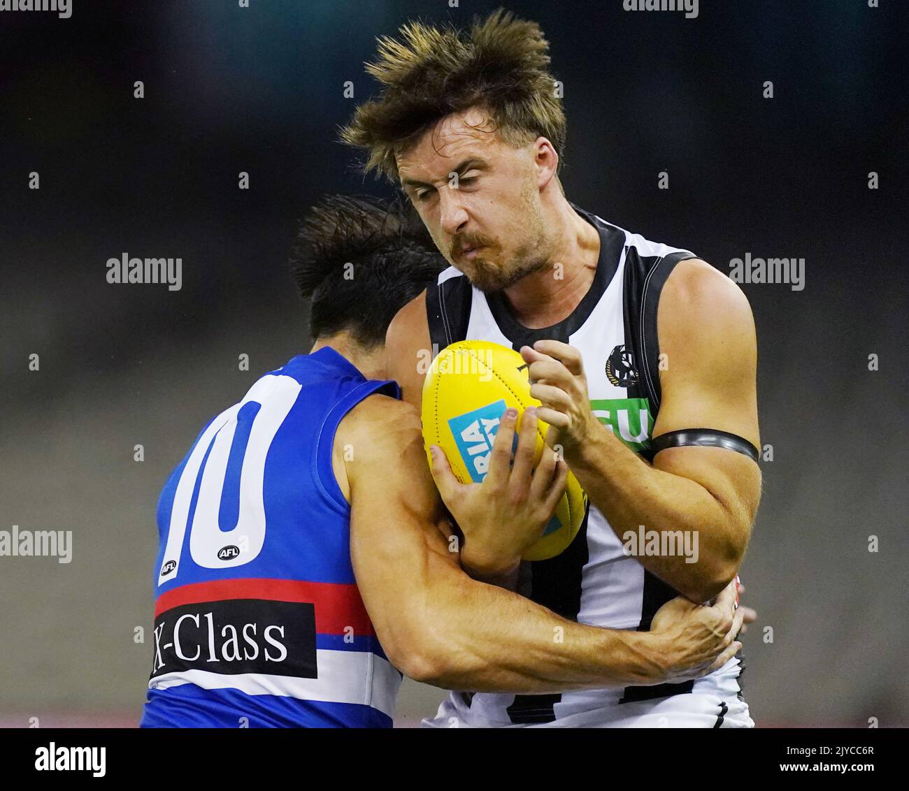 Tom Phillips of the Magpies gets crunched by Easton Wood of the ...