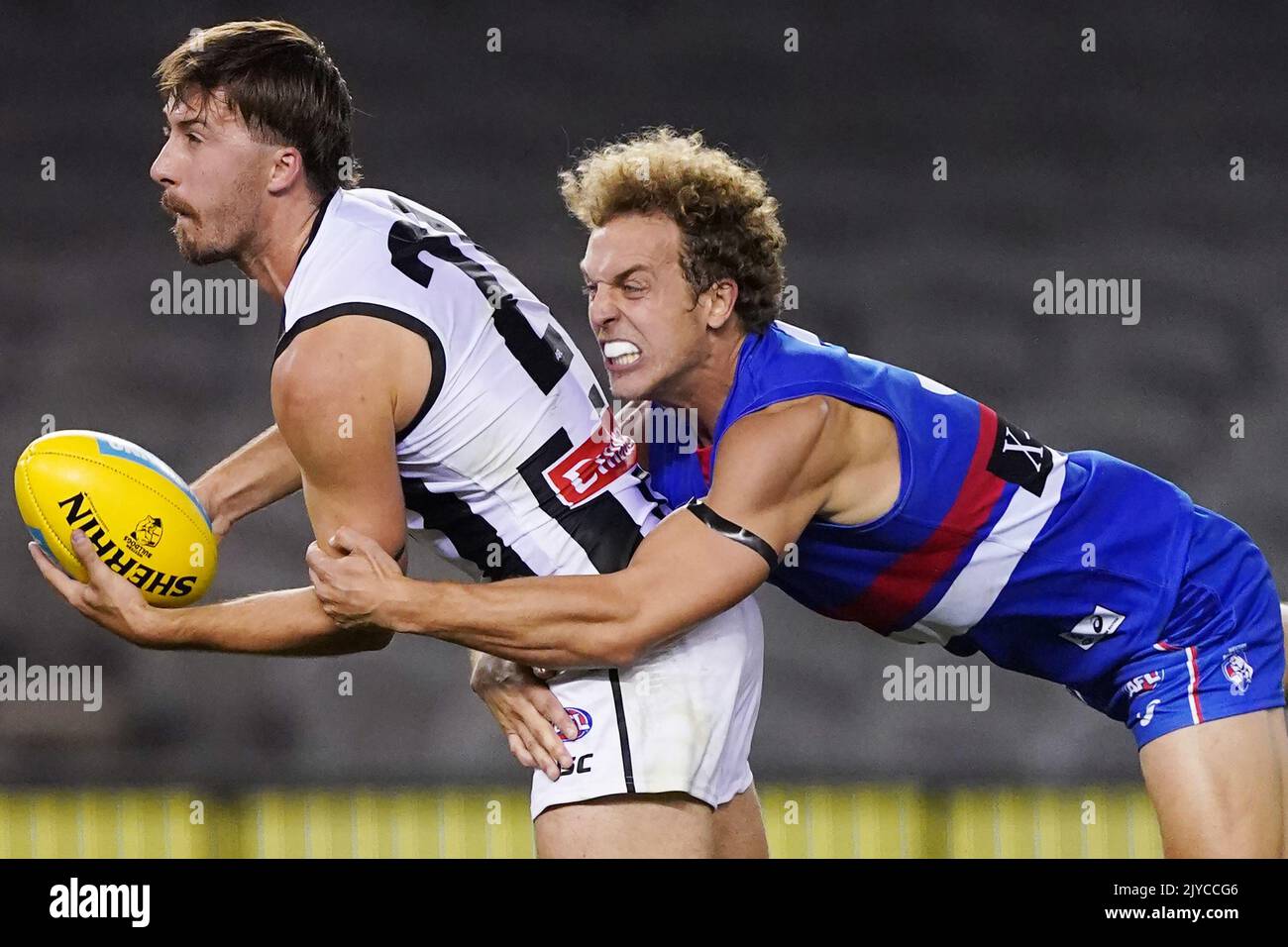 Mitch Wallis of the Bulldogs tackles Tom Phillips of the Magpies during ...