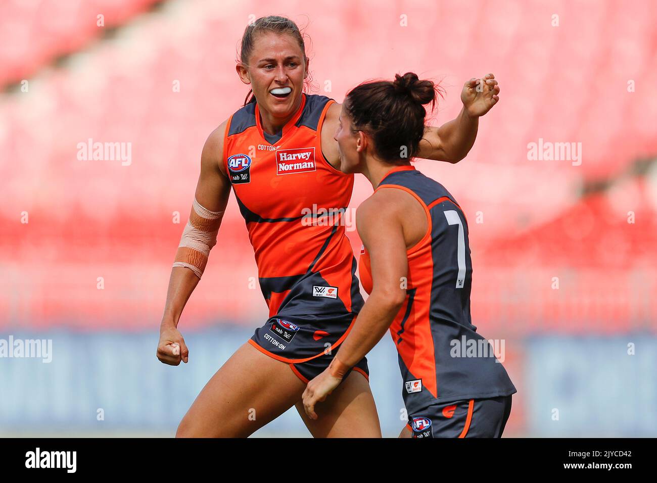 Aimee Schmidt of the Giants celebrates kicking a goal with team mate ...