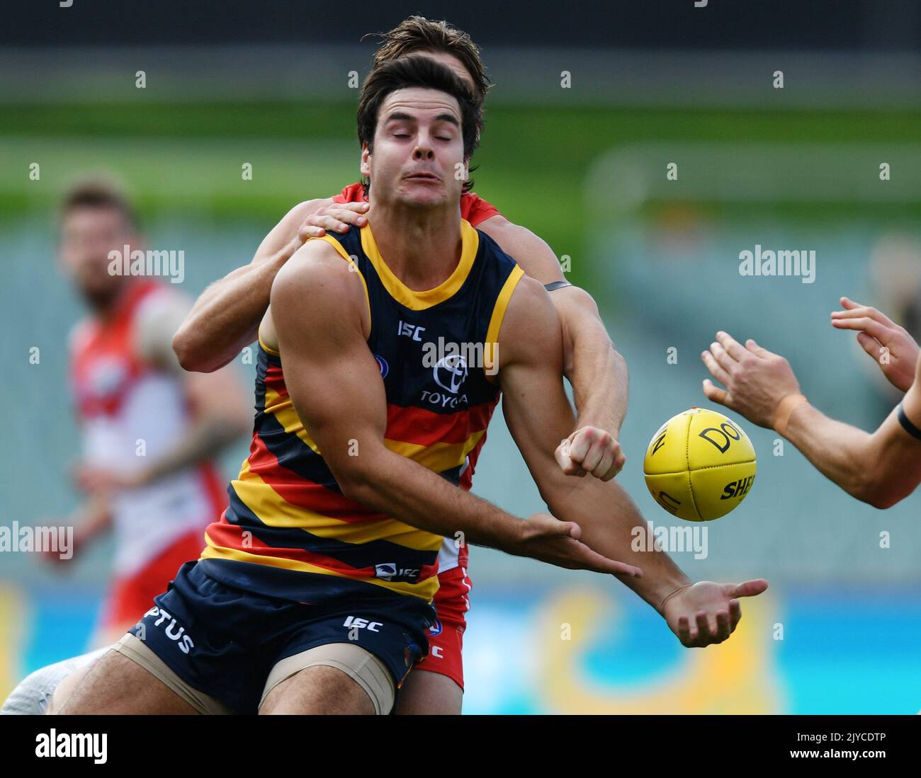 Darcy Fogarty of the Crows handballs during the Round 1 AFL match ...