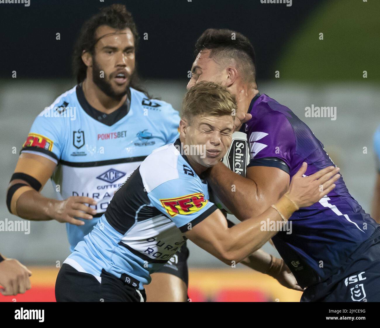 Blayke Brailey of the Sharks tackles Jesse Bromwich of the Storm during ...