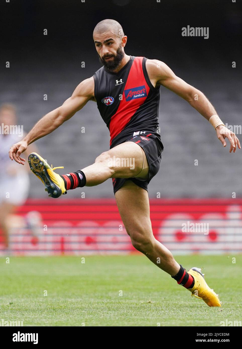 Adam Saad of the Bombers kicks the ball during the Round 1 AFL match ...