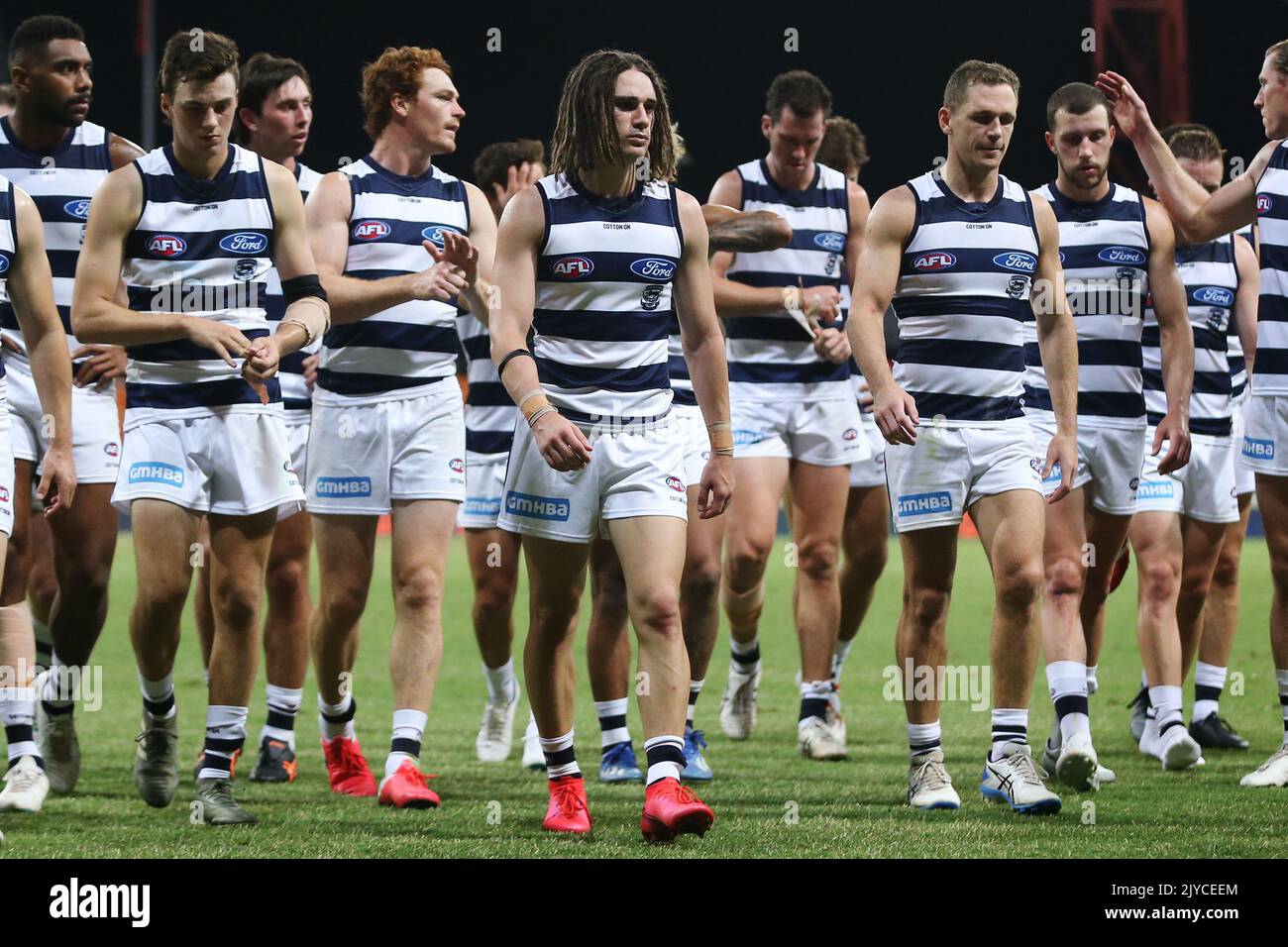 Cats players walk from the field during the Round 1 AFL match between ...