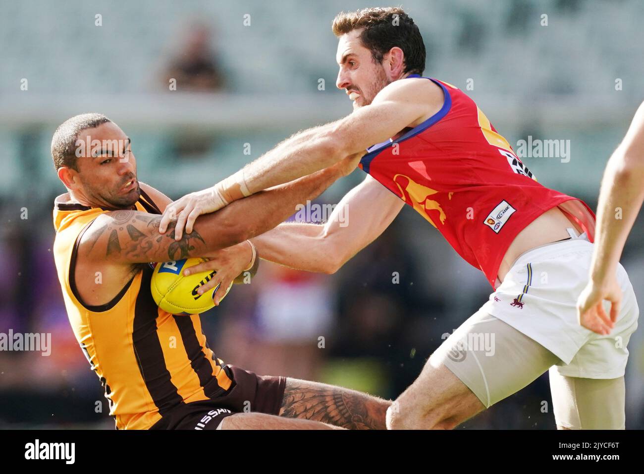 Darcy Gardiner of the Lions tackles Shaun Burgoyne of the Hawks during ...