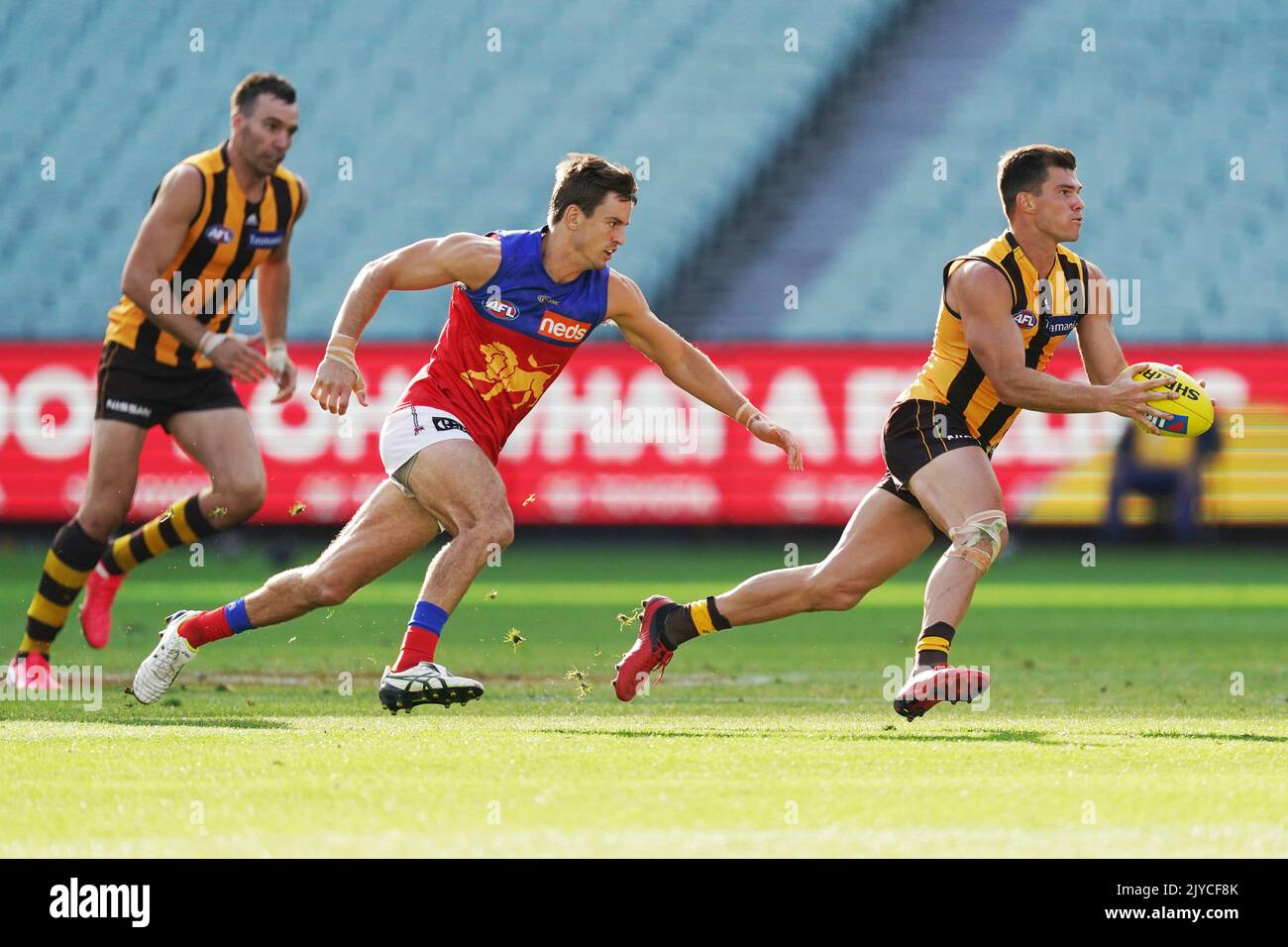 Jaeger OMeara of the Hawks runs with the ball from Hugh McCluggage of ...