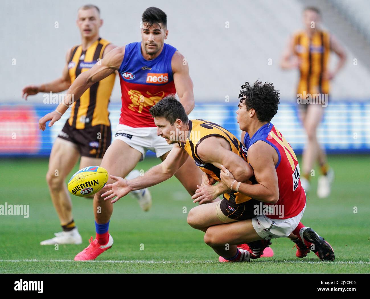 Cameron Rayner of the Lions tackles Liam Shiels of the Hawks during the ...