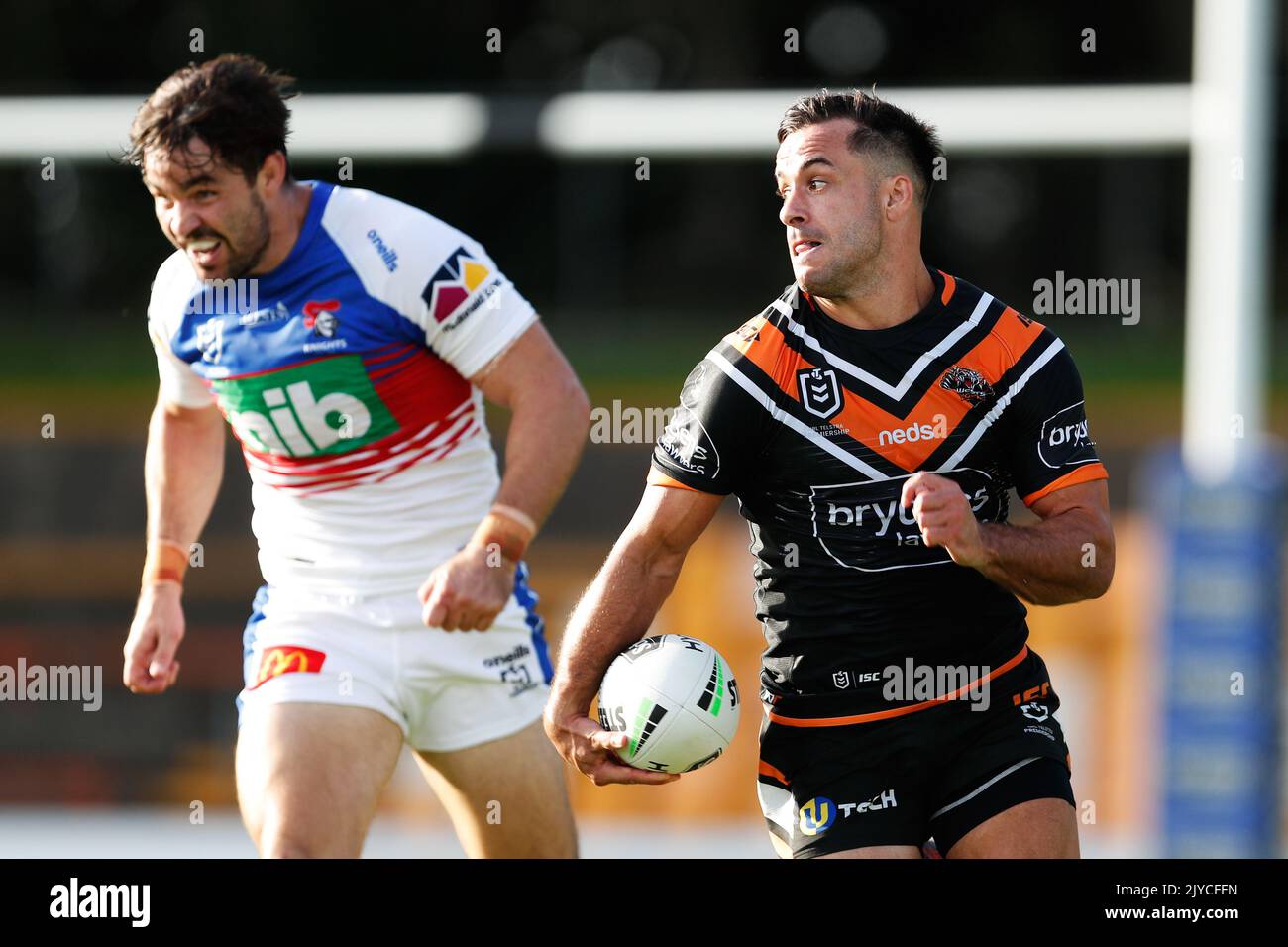 Corey Thompson of the Tigers runs the ball during the Round 2 NRL match ...