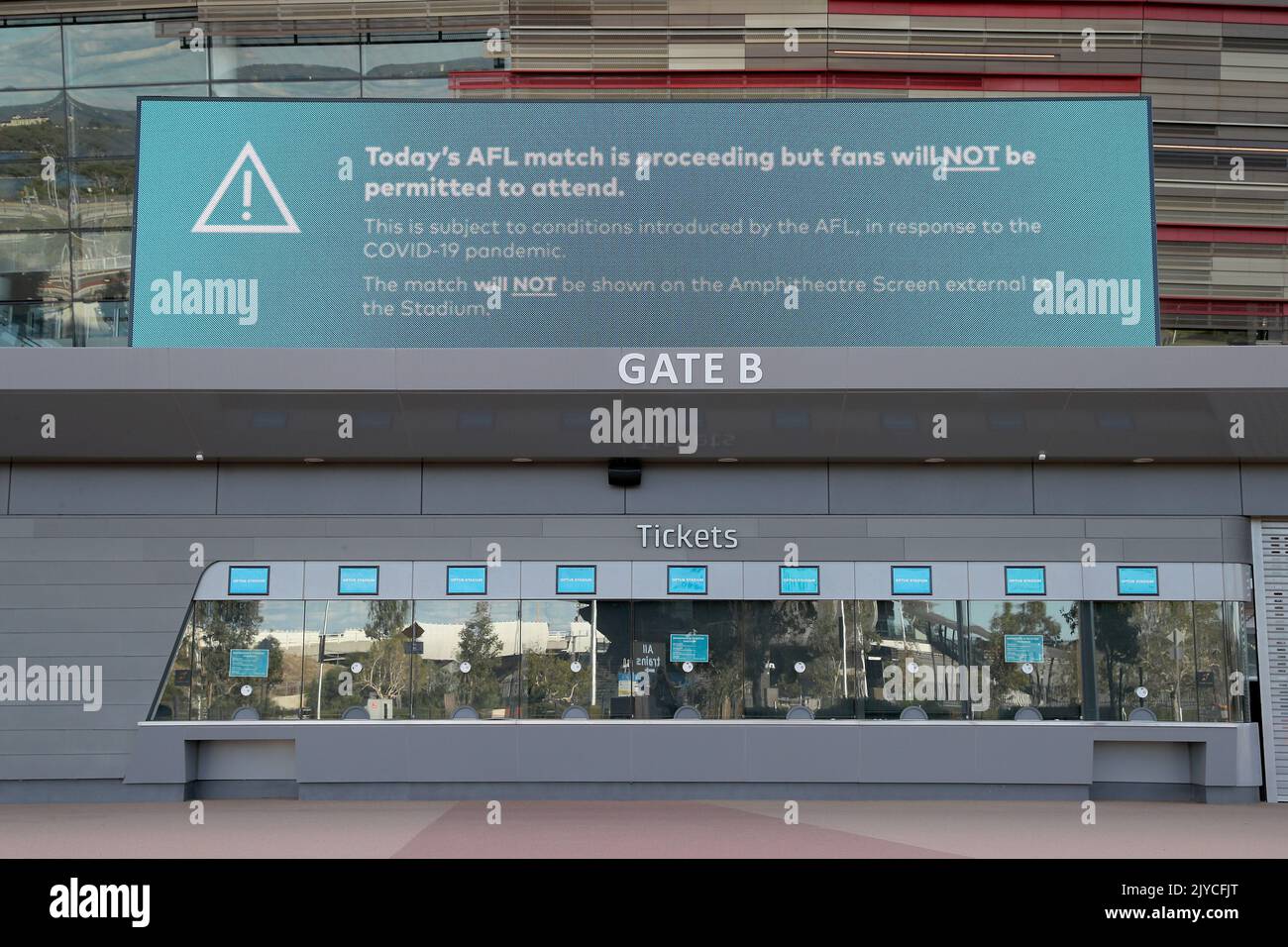 An electronic sign at Optus Stadium stating the Round 1 AFL match ...