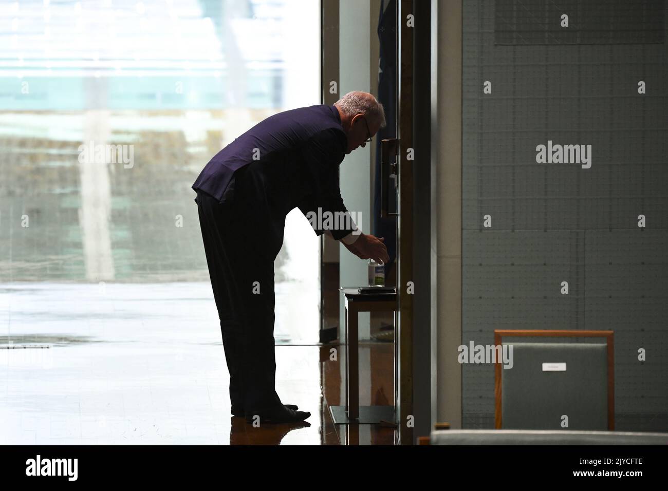 Australian Prime Minister Scott Morrison uses hand sanitizer as he ...