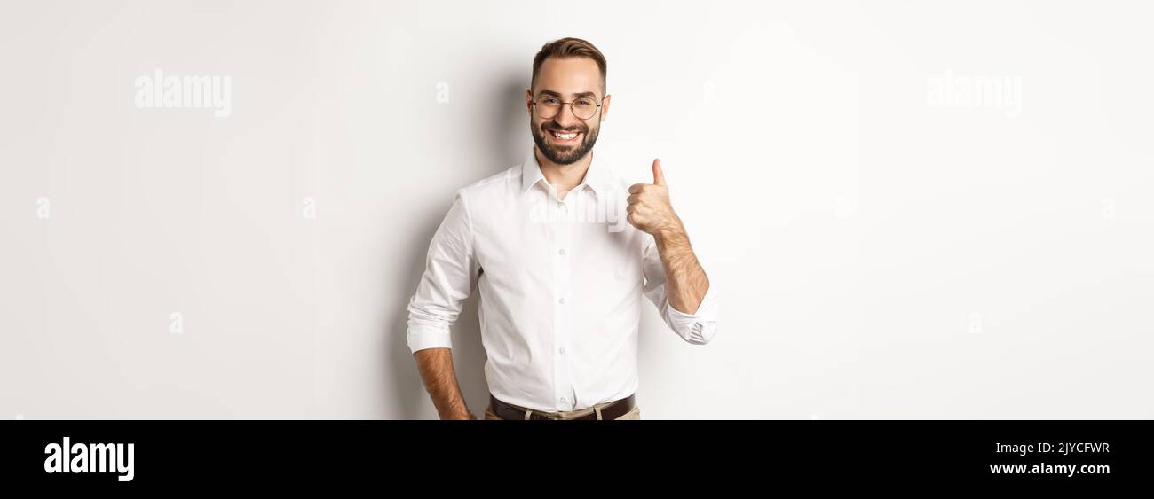 Satisfied successful boss showing thumb up, approve and praise good ...