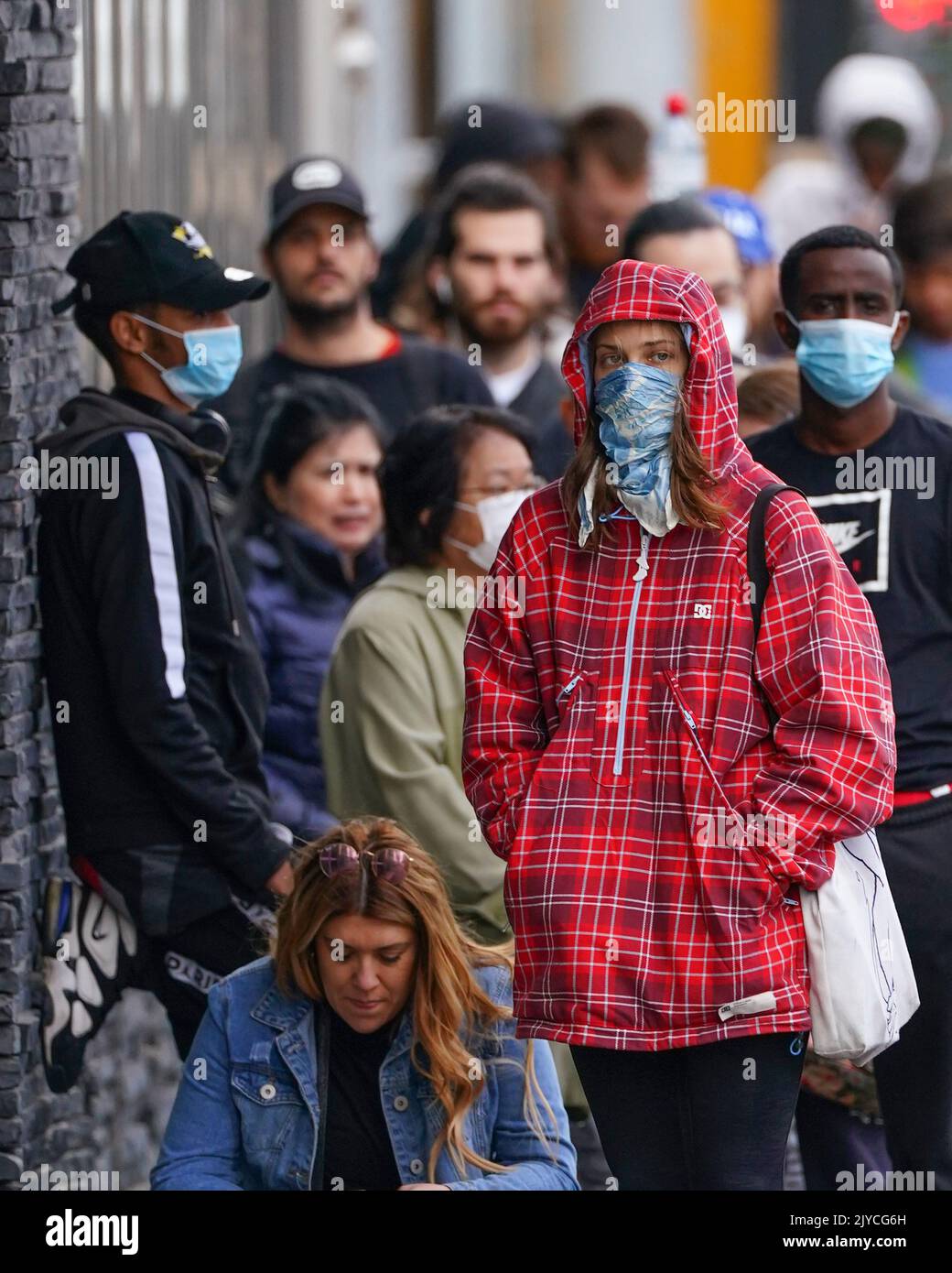 People are seen in long queue outside a Centrelink office in Abbotsford ...