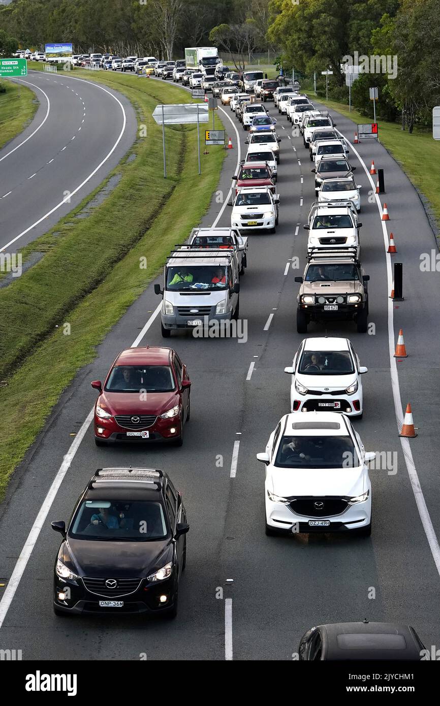Long lines of traffic build before a motorists are stopped at a ...
