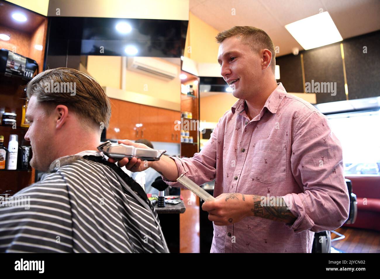 Addison Manning cuts a client's hair at a barber shop in Toowoomba ...
