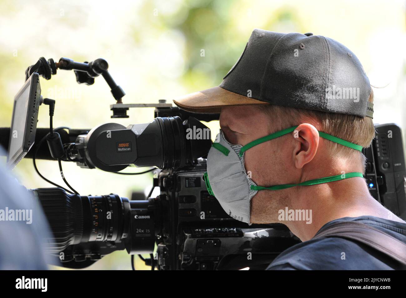 Media cameramen wear masks during a press conference in Sydney ...