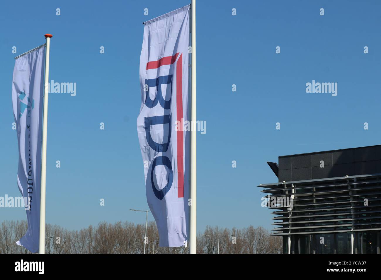 Flags in front of a office of accountancy BDO in The Hague the ...
