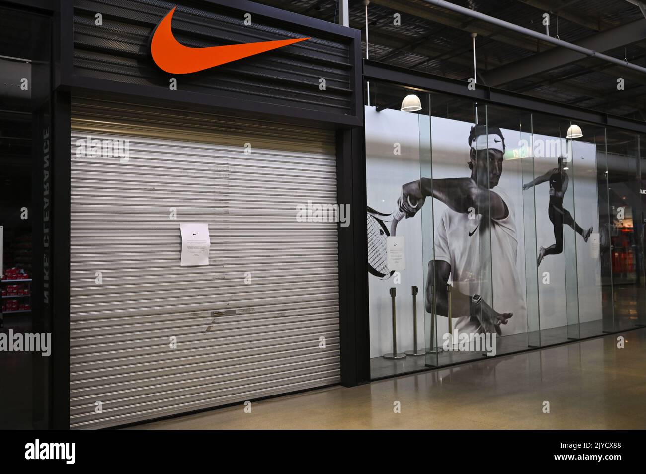 A closed shop front is seen inside an Outlet Shopping Centre in ...