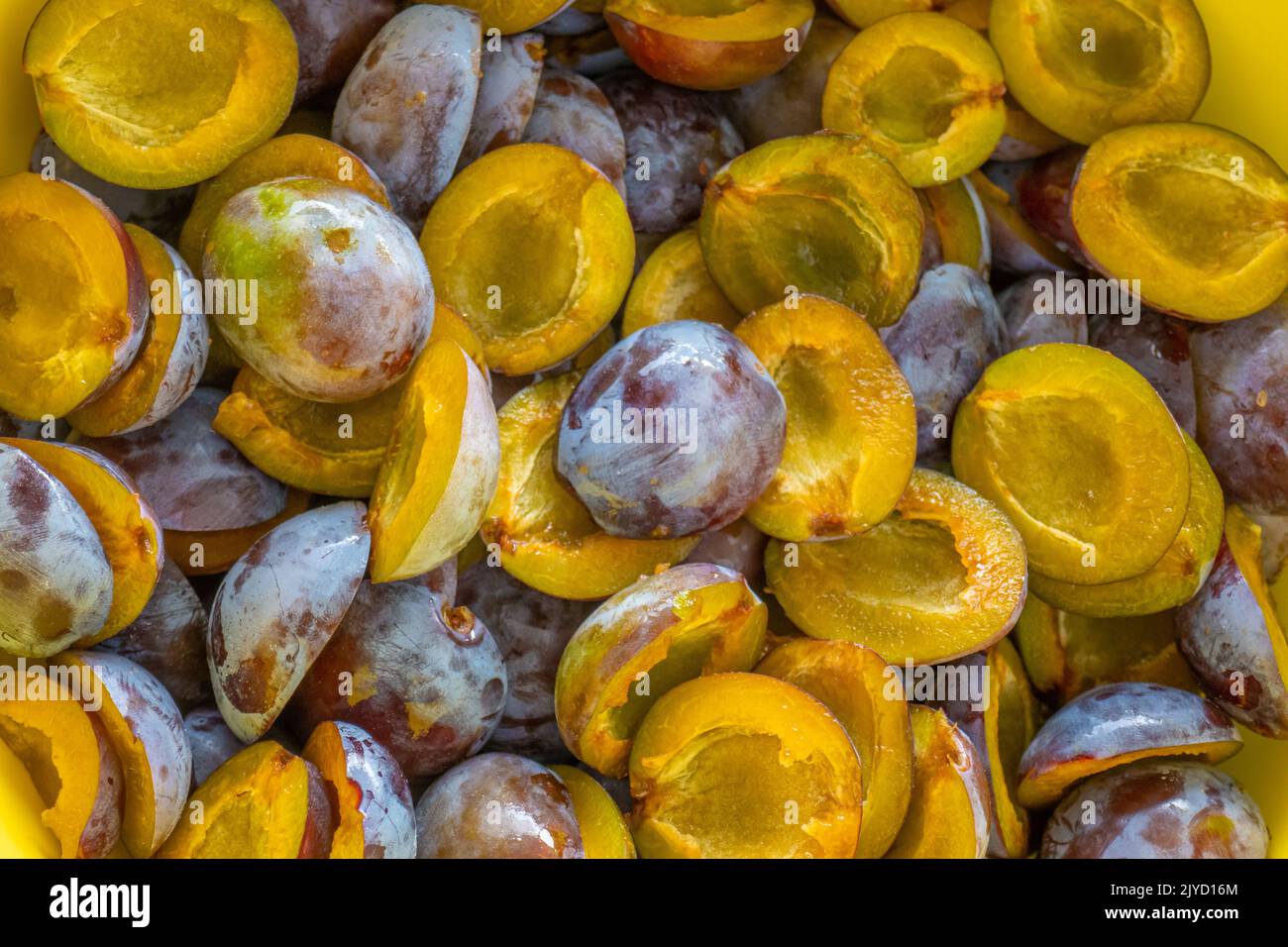 Plum halves background.Yellow pulp of fruits. Juicy pulp texture.Farm ...