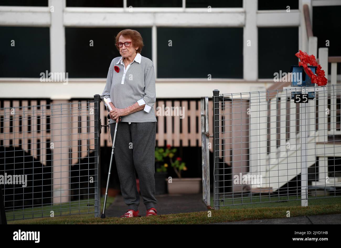 90 year-old Kathleen Callaghan stands outside her home at dawn to ...