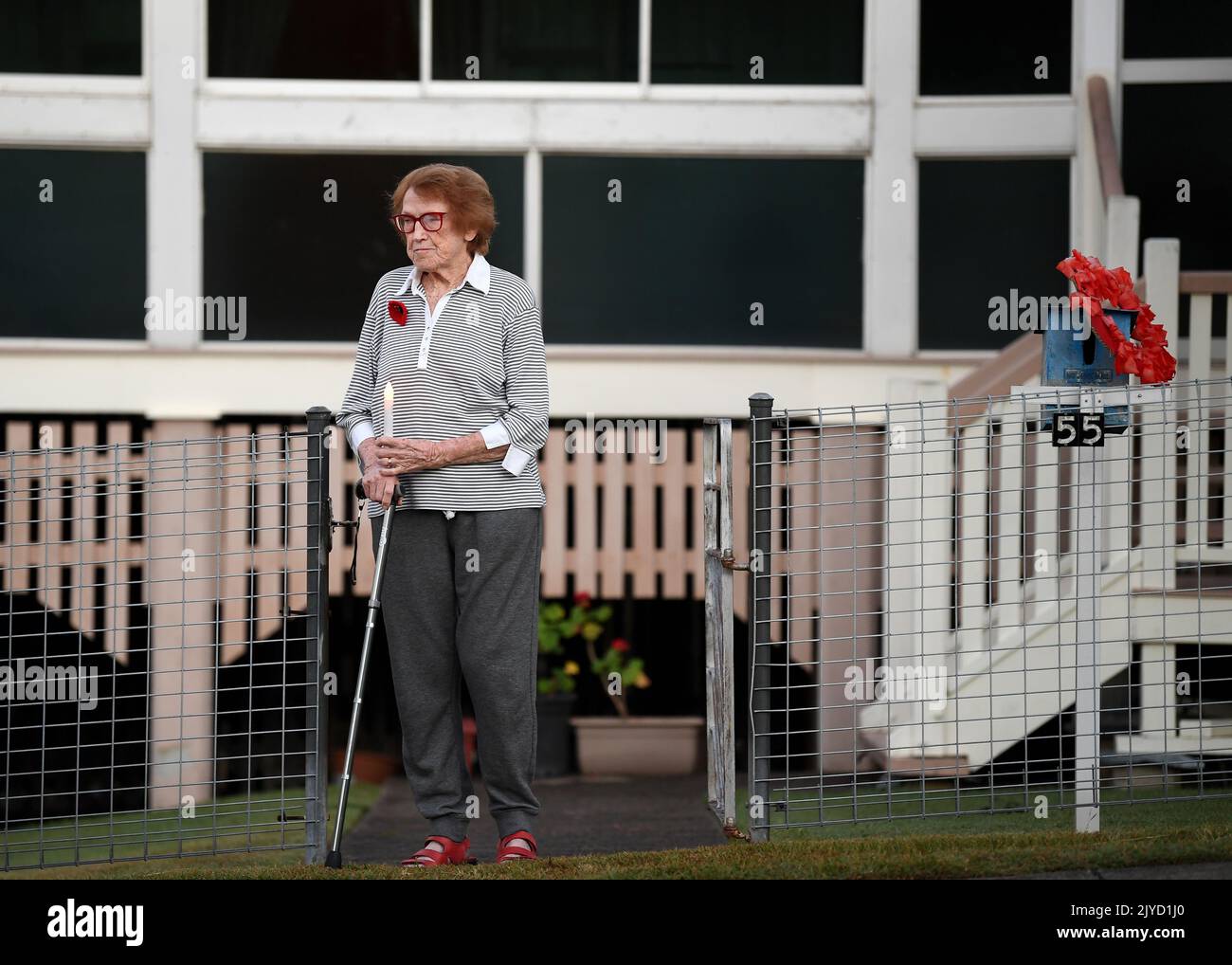 90 year-old Kathleen Callaghan stands outside her home at dawn to ...