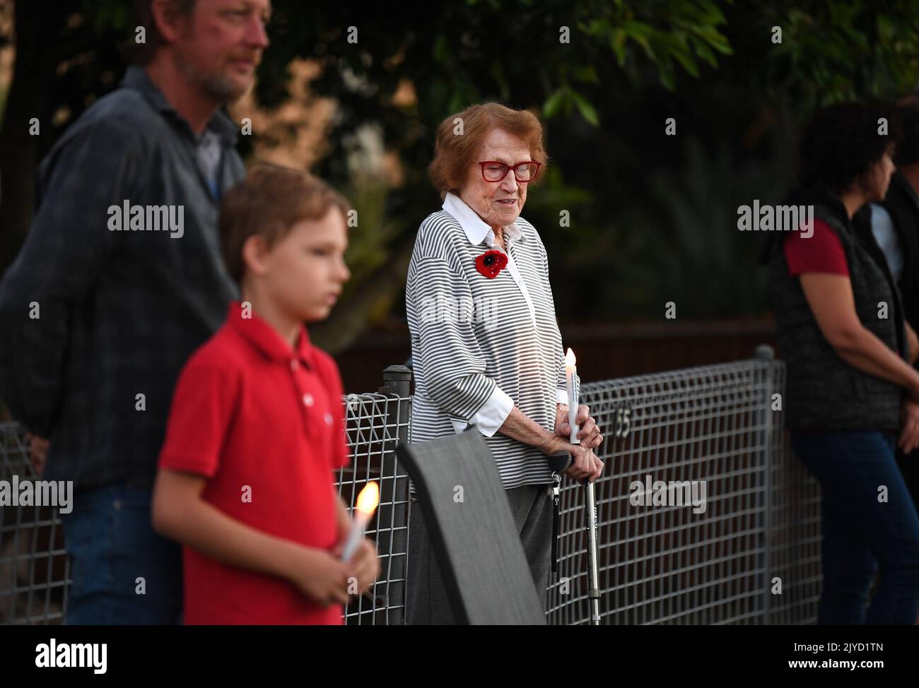 90 year-old Kathleen Callaghan is joined by neighbours as she stands ...