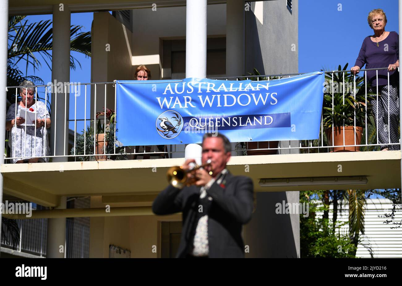 War widows watch musician Alastair Tomkins as he plays his trumpet ...
