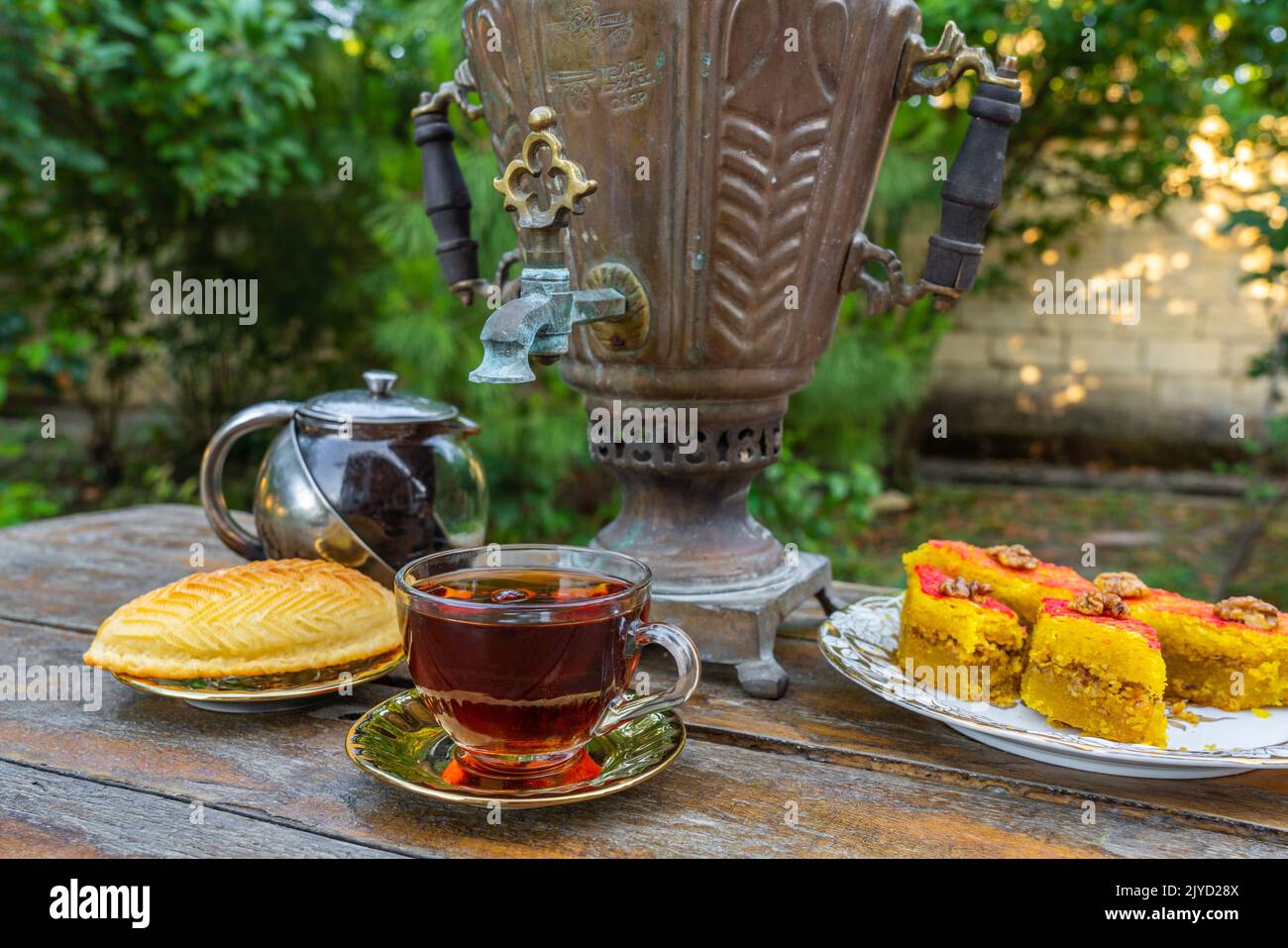 Tea drinking from a vintage samovar with oriental sweets Stock Photo ...