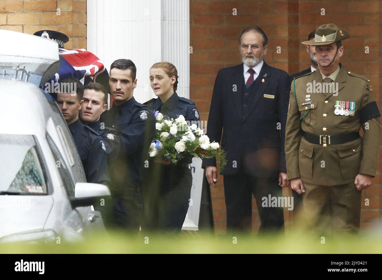 Todd Robinson (R), the partner of Glen Humphris, looks on as the coffin ...