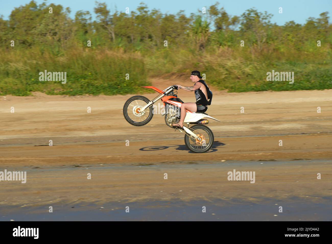 A local rides a dirt bike at Gunn Point Beach on the outskirts of ...