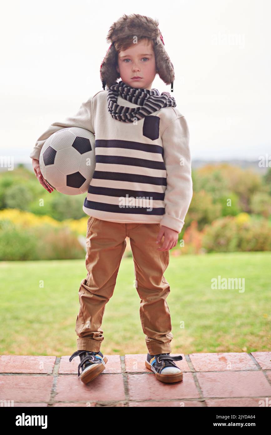 I wish I had a friend to play with. a little boy standing outside in ...