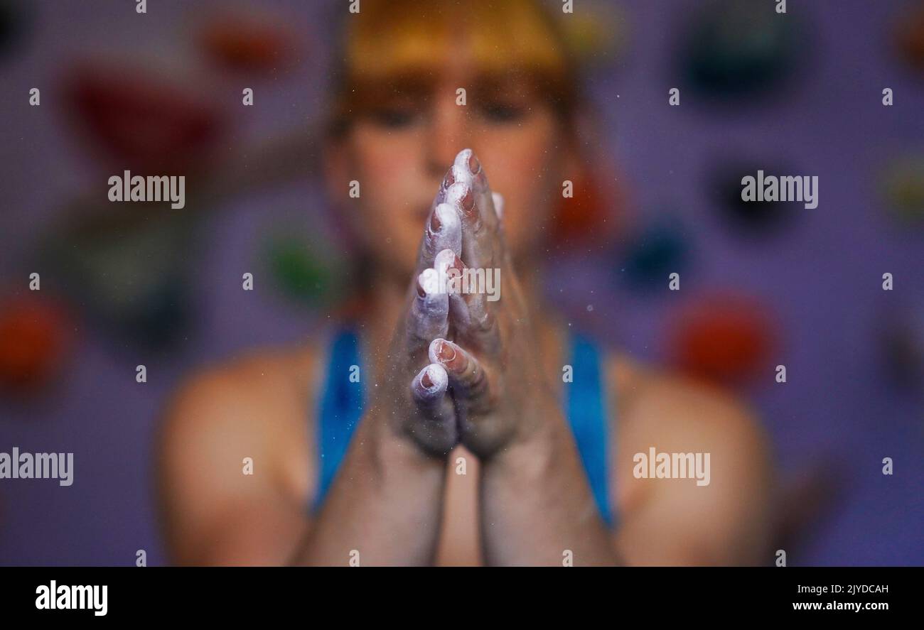 Australian climber Oceana Mackenzie chalks up her hands as she trains ...