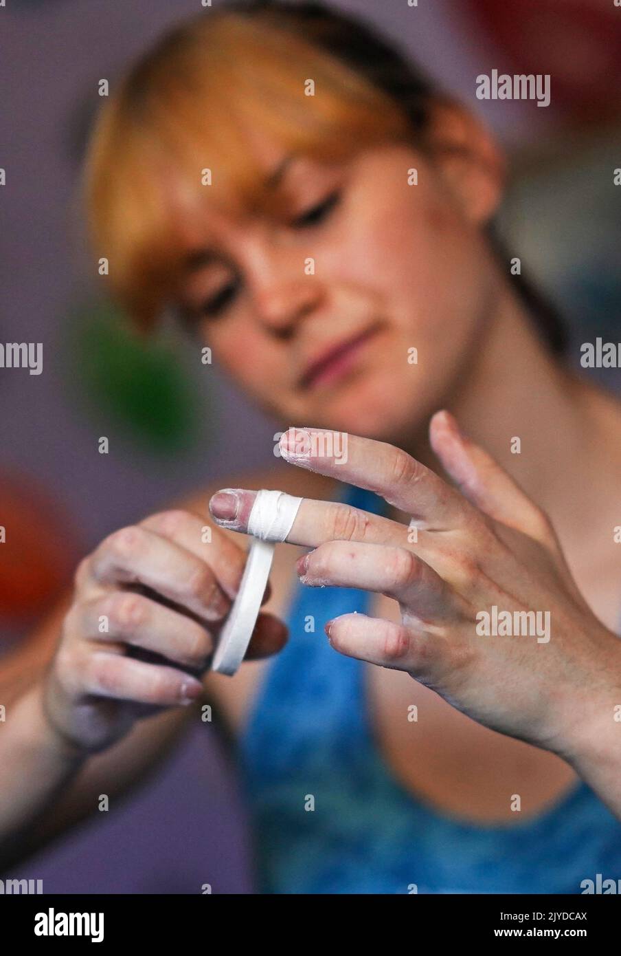 Australian climber Oceana Mackenzie tapes up her hands as she trains at ...