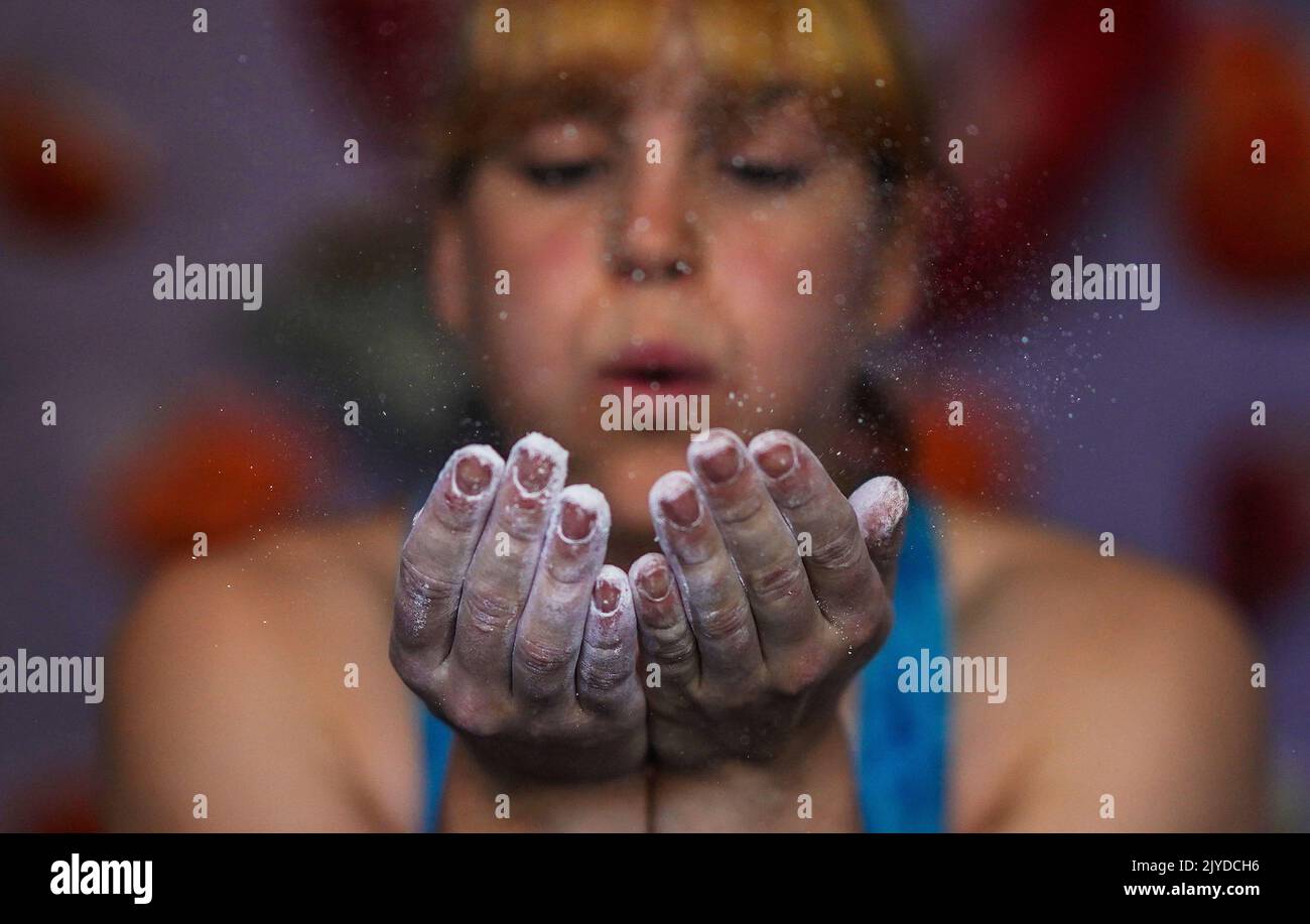 Australian climber Oceana Mackenzie chalks her hands as she trains at ...