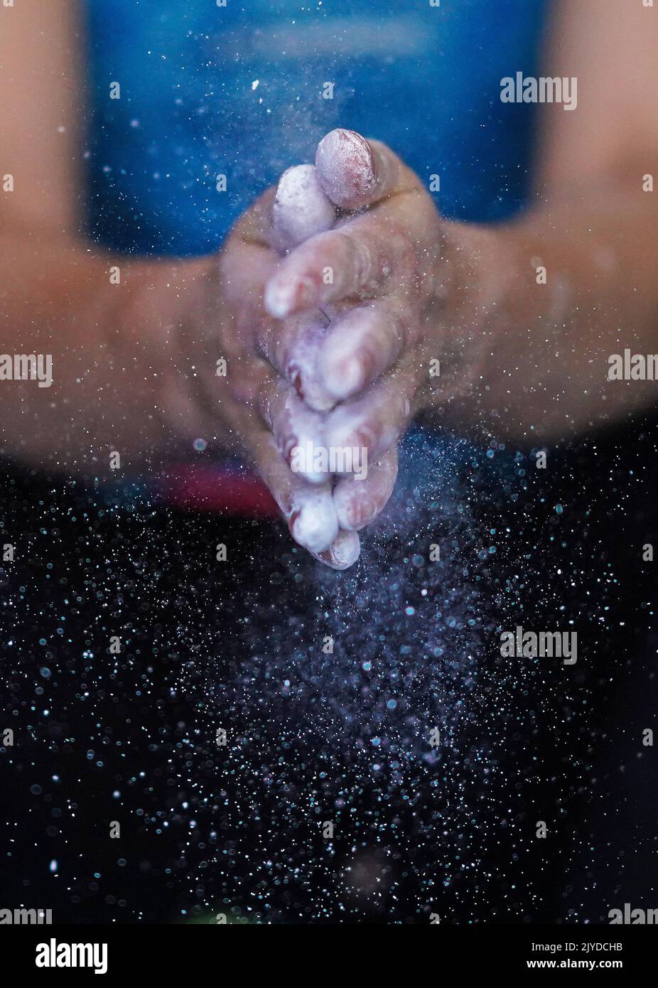 Australian climber Oceana Mackenzie chalks her hands as she trains at ...