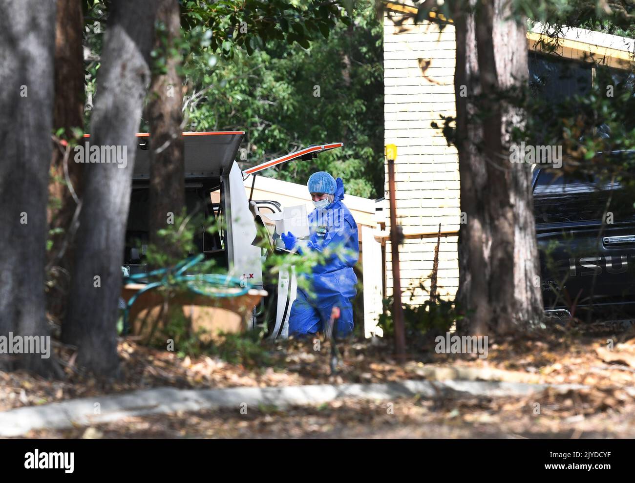 A police forensic officer tends to the scene of the suspected double ...