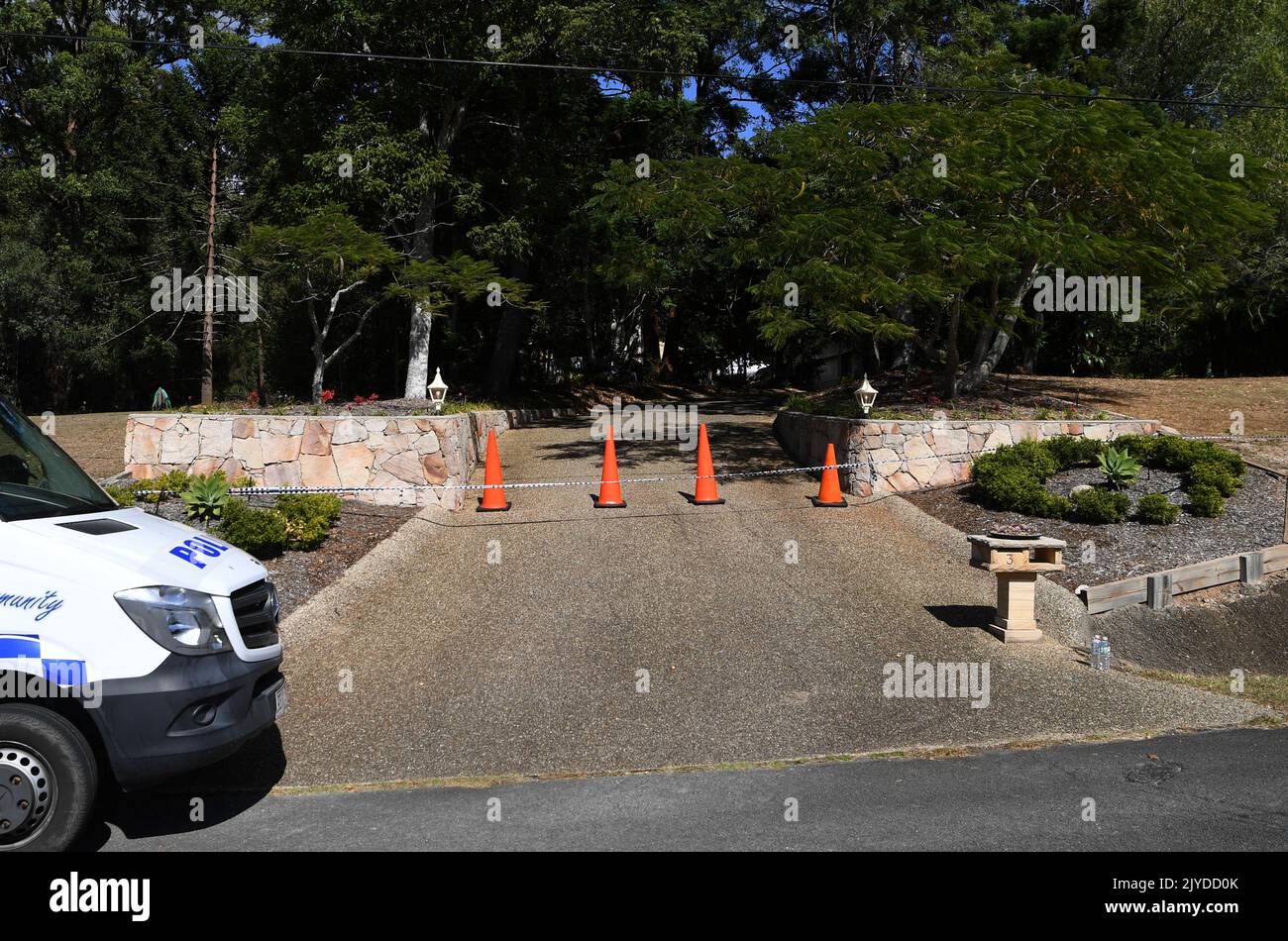 Police tape is seen at the entrance to a driveway at the scene of the ...