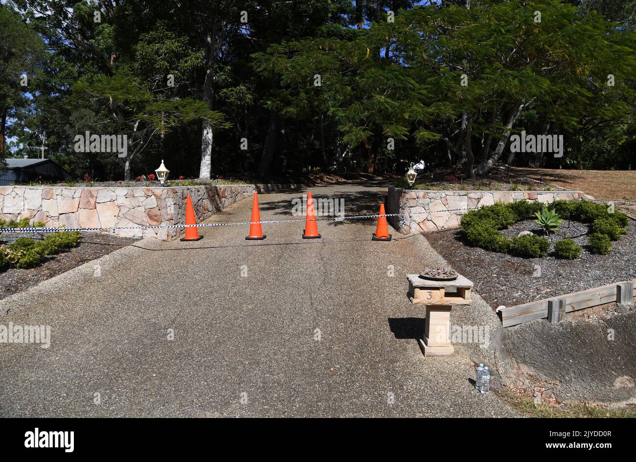 Police tape is seen at the entrance to a driveway at the scene of the ...