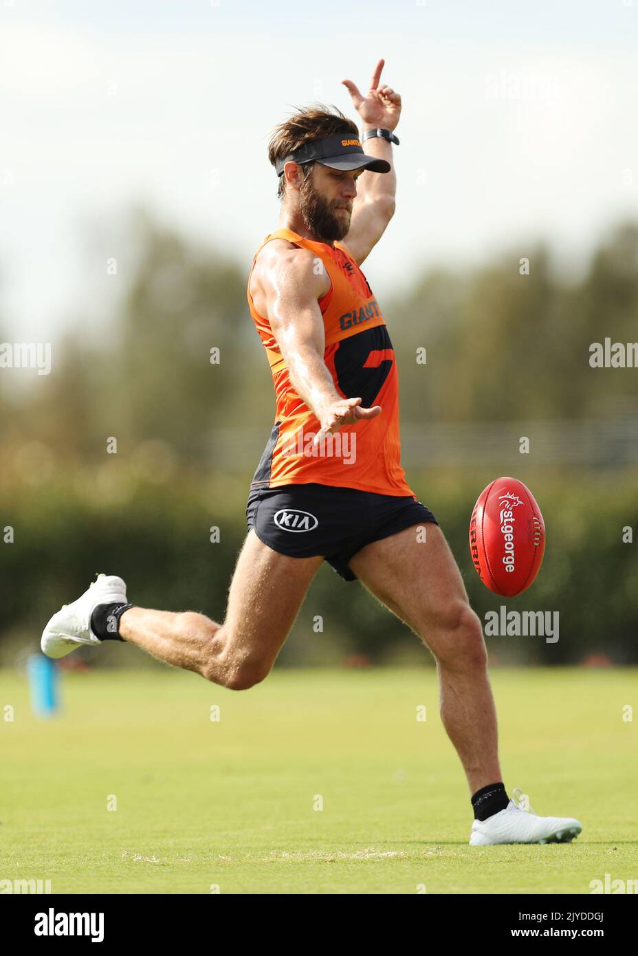 Matt De Boer of the Giants kicks during a GWS Giants training session ...