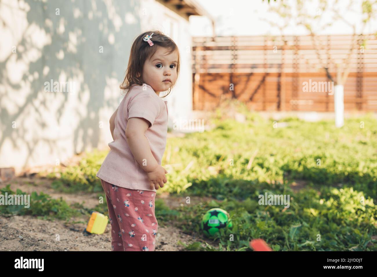 Child standing alone in playground hi-res stock photography and images ...